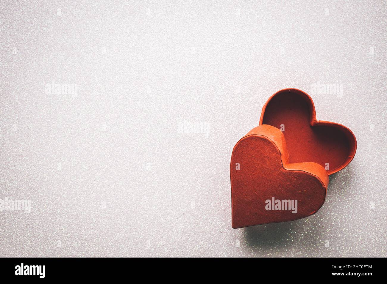 Red heart, half open decorative gift box for a loved one, silvery ...