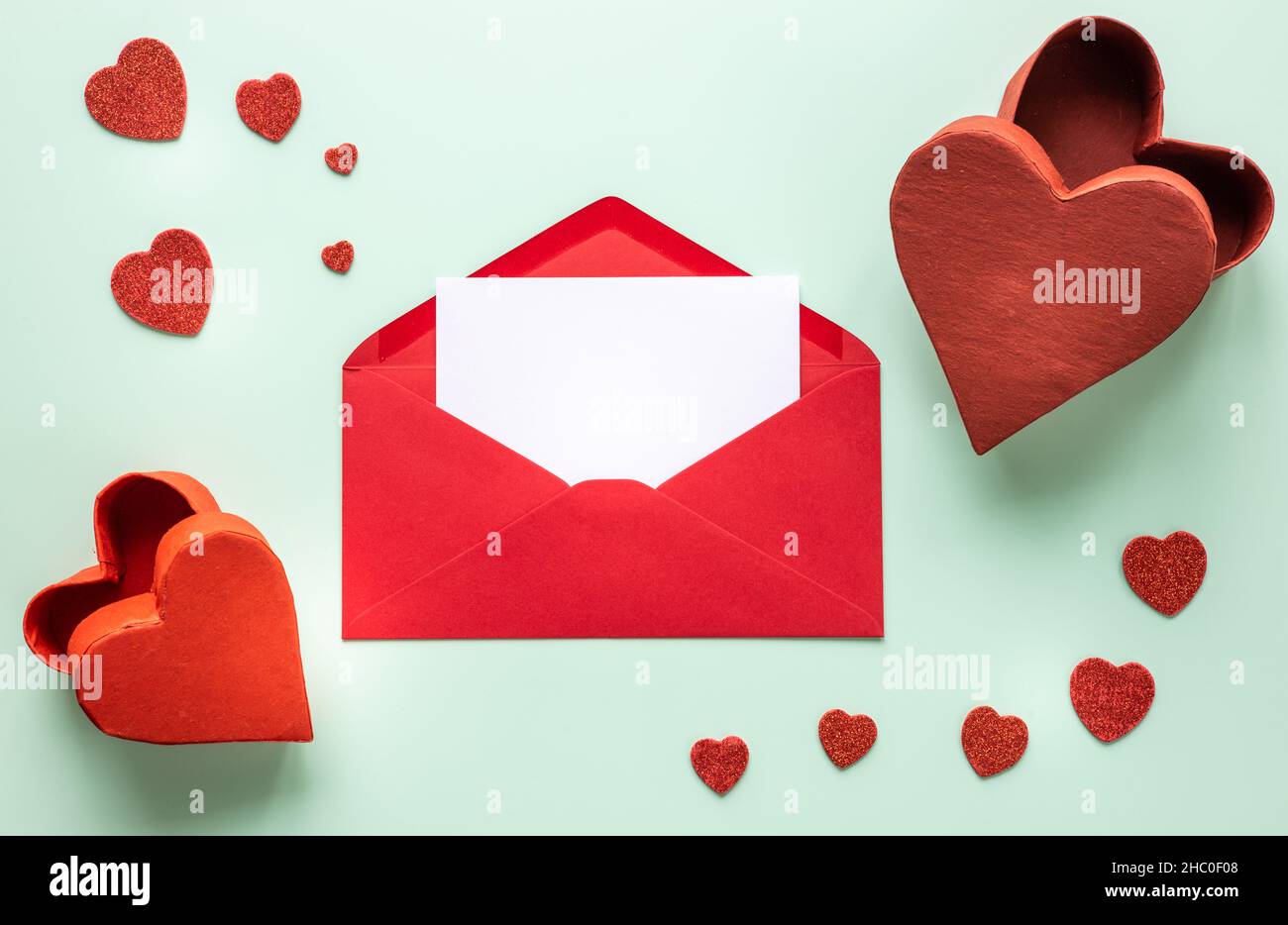 open red envelope with blank letter paper on pastel green background ...