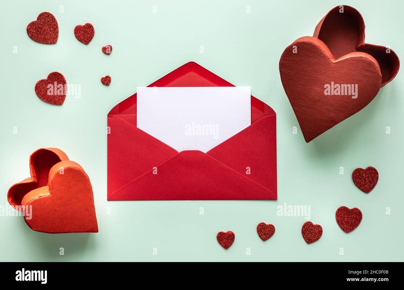 open red envelope with blank letter paper on pastel green background ...