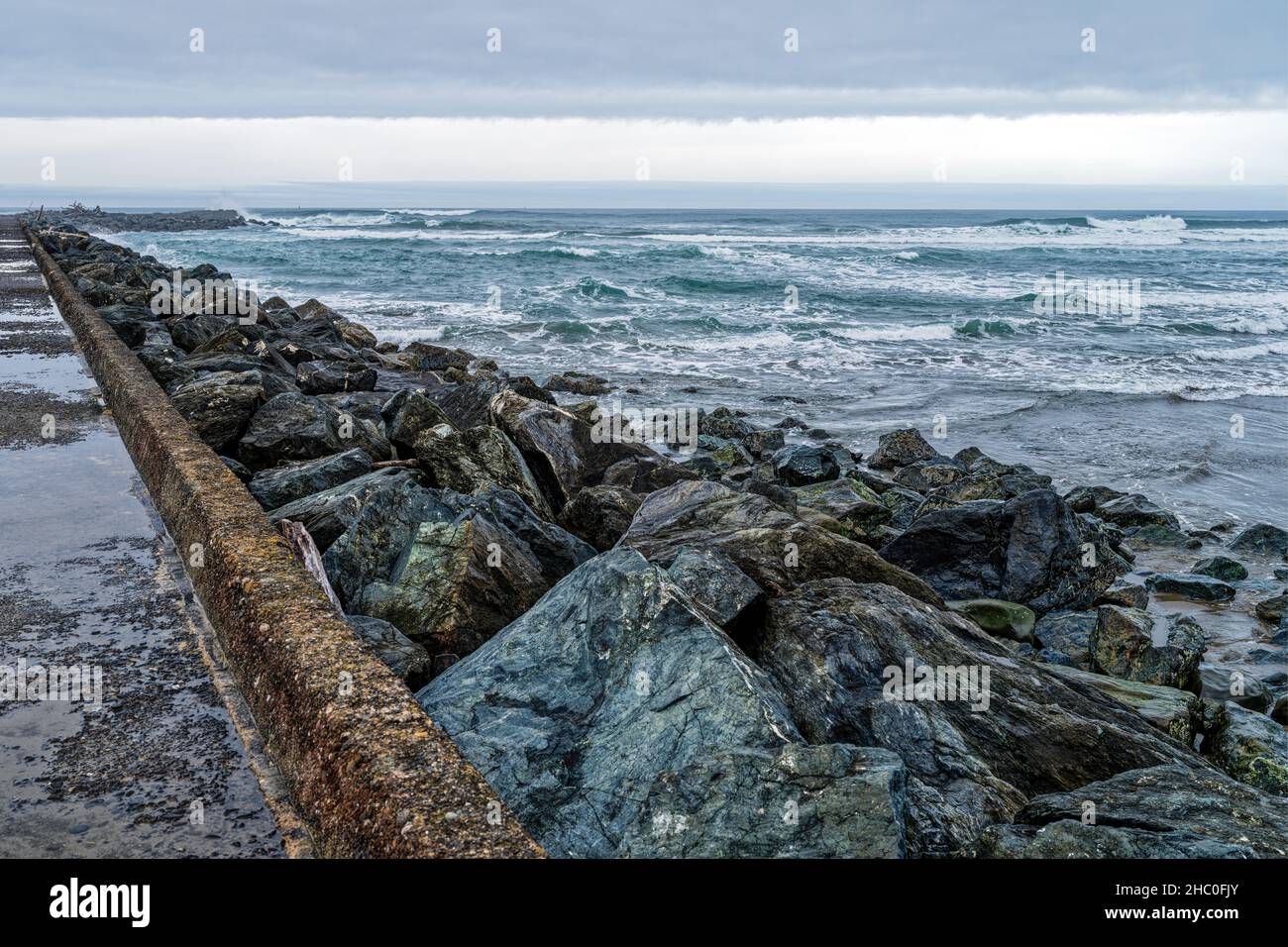 Rocks along the jetty where the Coquille River flows into the Pacific ...