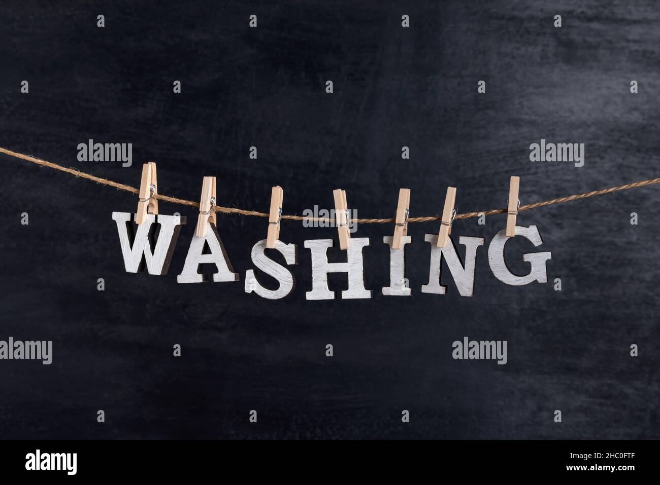 Words WASHING with clothespins on black background. Concept of laundry ...