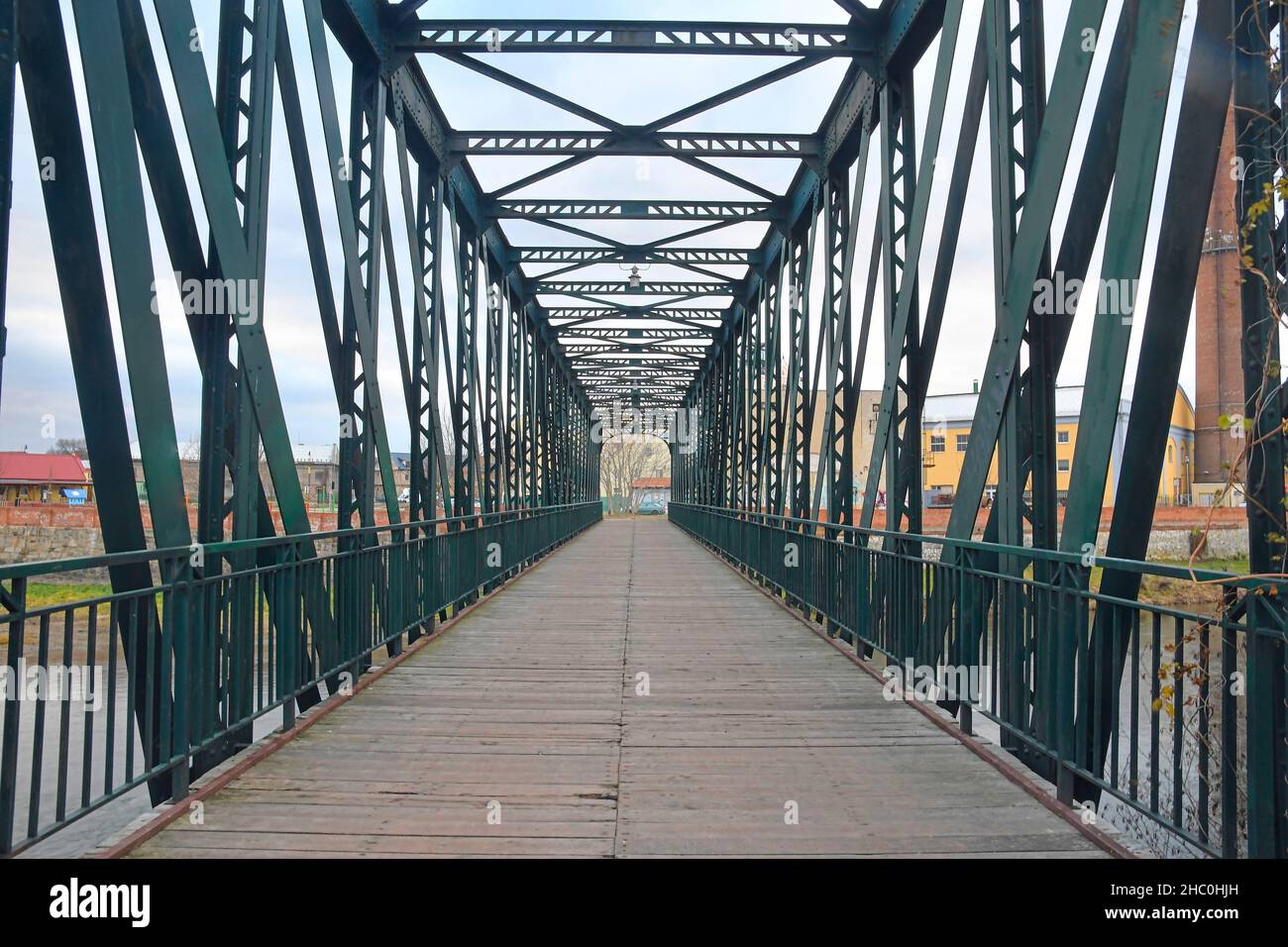 Old metal overpass, bridge over the river. Rivet metal bridge in town ...