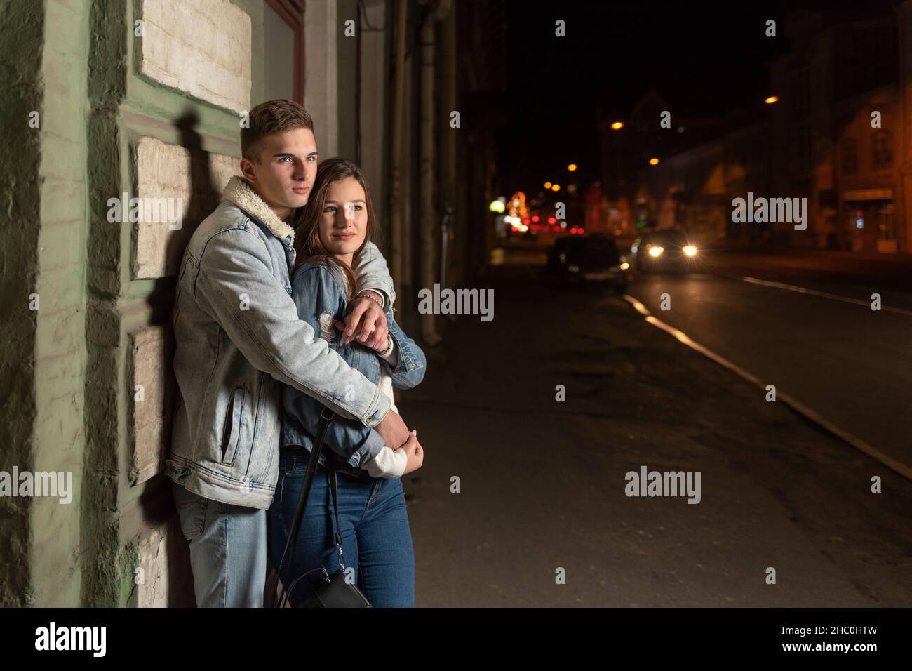 Handsome Young Guy Hugs His Girlfriend On Night City Background Young
