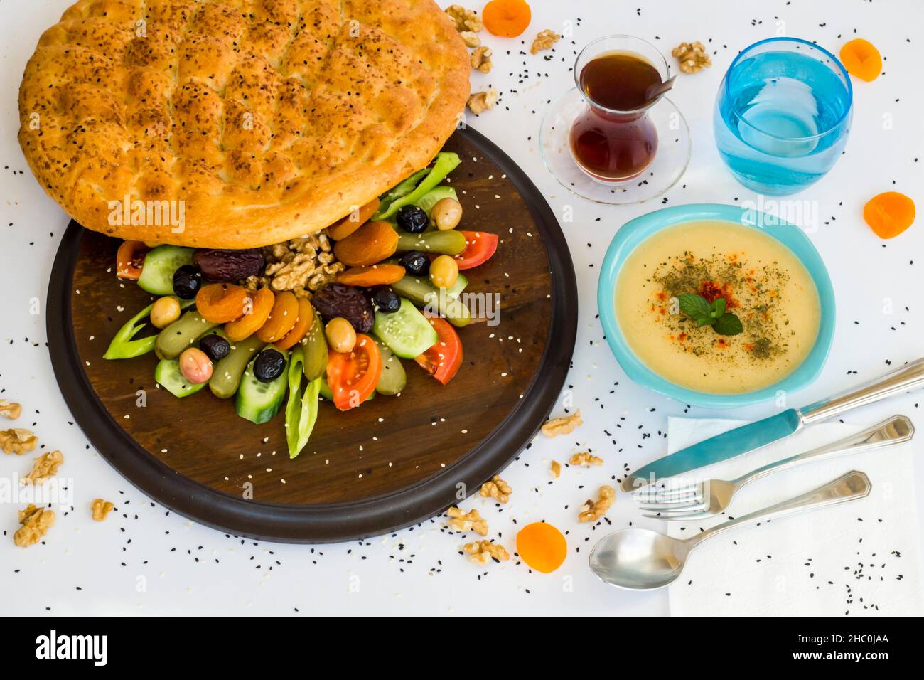 Traditional Ramadan Iftar Plate on white with soup,water,bread and tea ...
