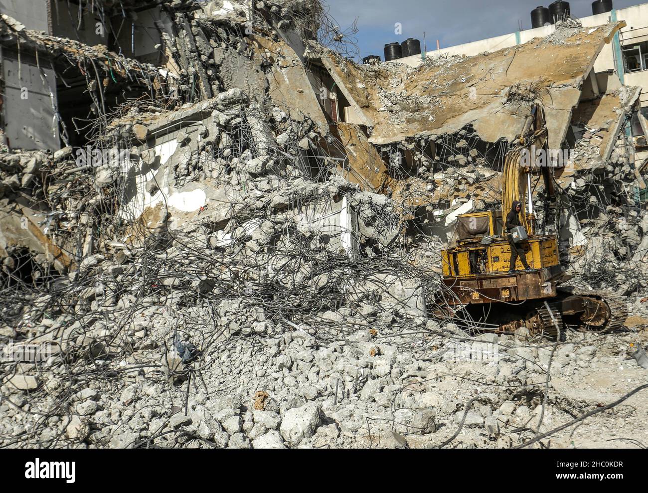 A bulldozer removes debris of Al-Jawharah Tower that was hit by Israeli ...