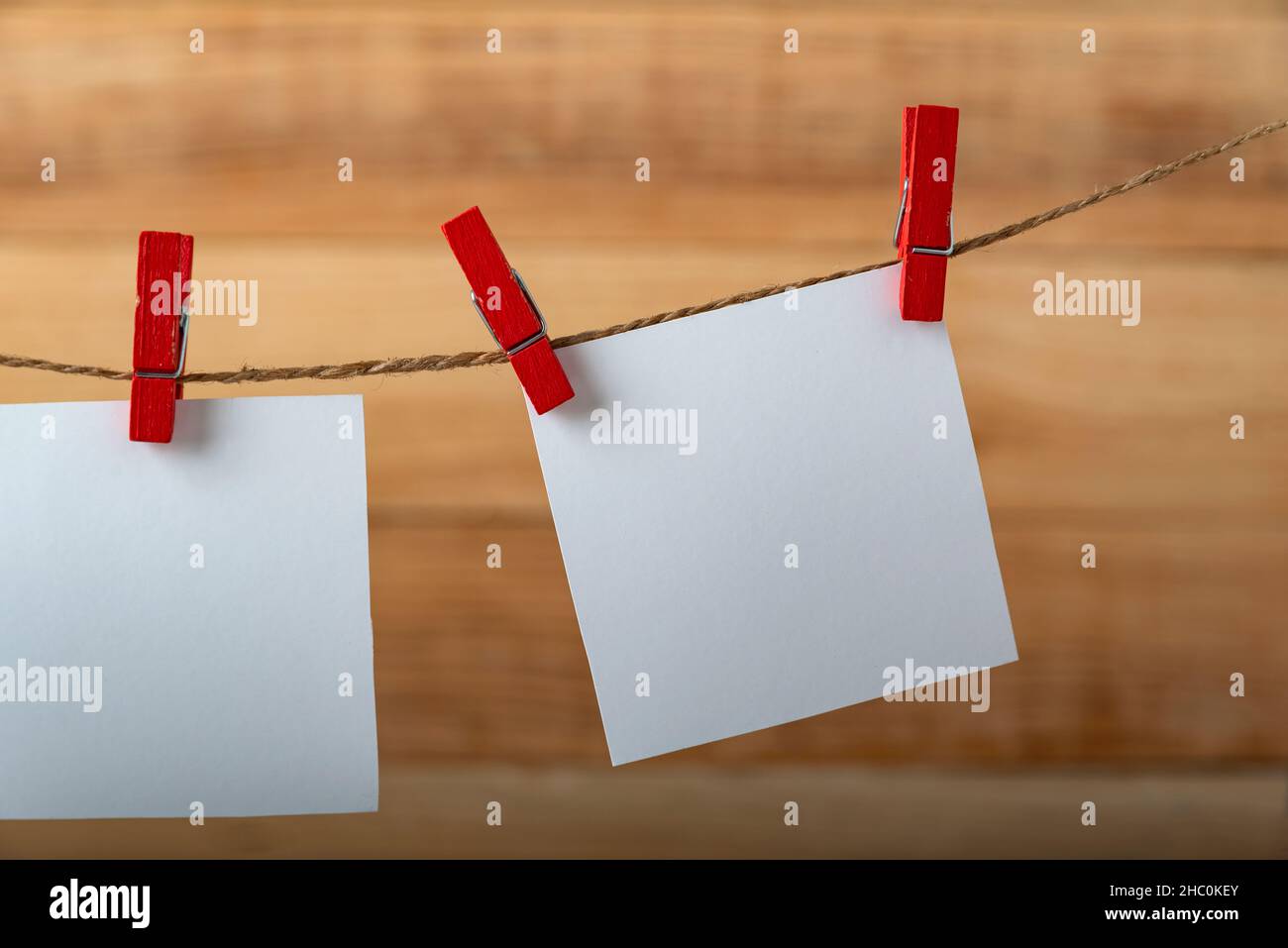 Blank square note paper card hanging with wooden clip or clothespin on ...