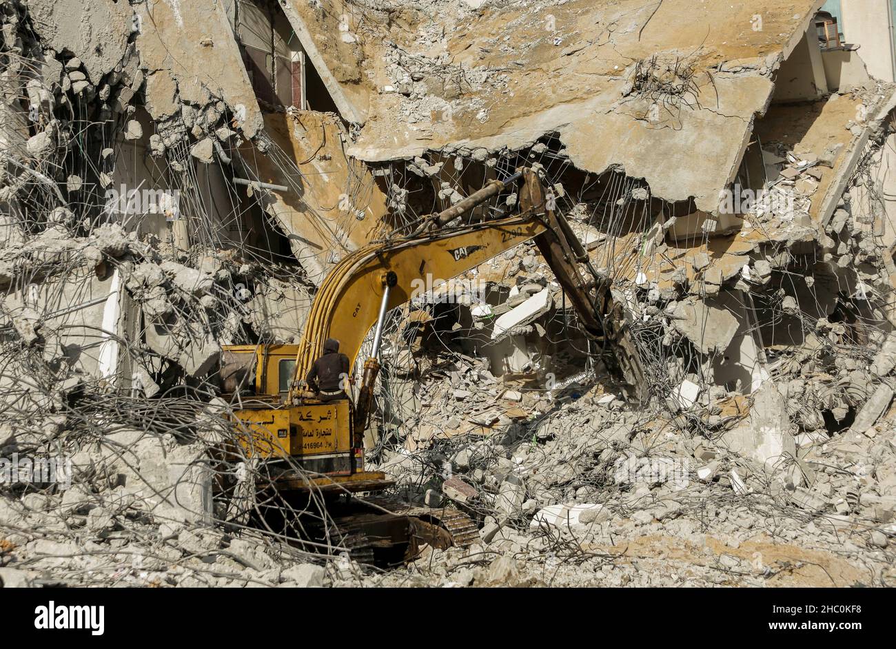 A bulldozer removes debris of Al-Jawharah Tower that was hit by Israeli ...