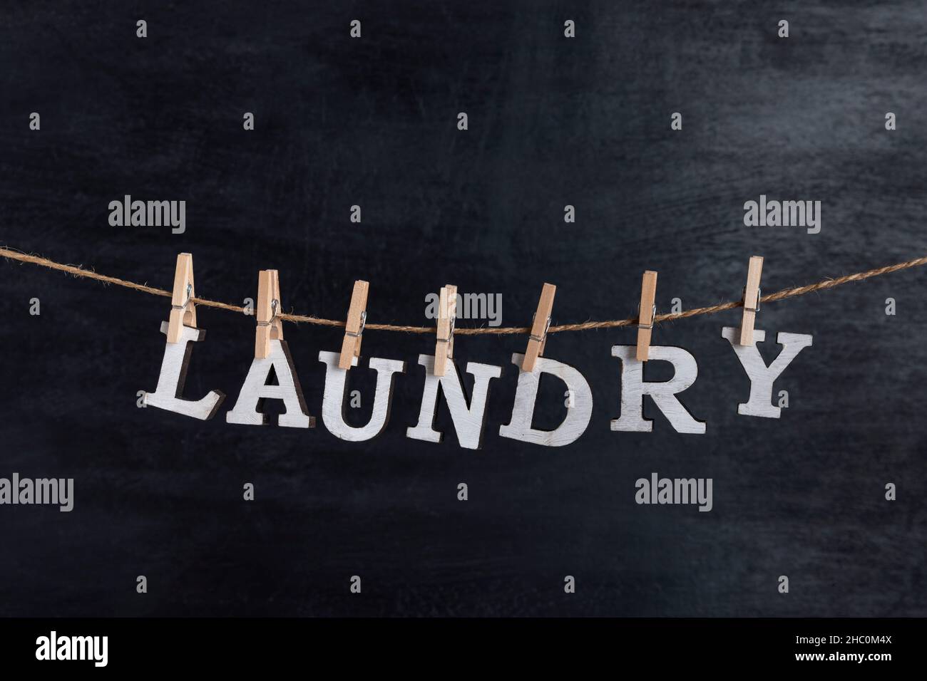 Word LAUNDRY is hung on clothespins. Dry cleaning. Cleaning service ...