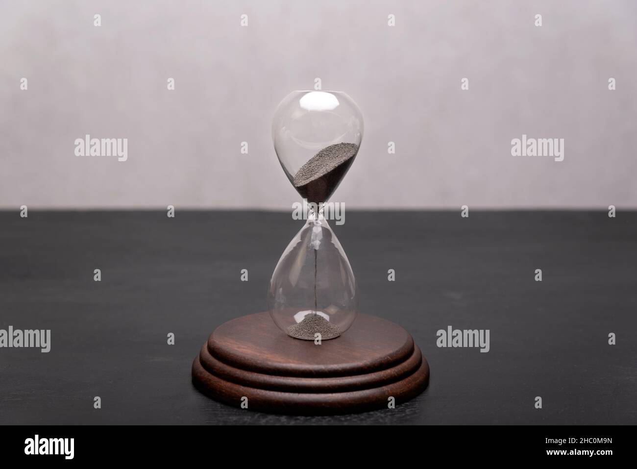 Hourglass on a stand. Time is running out. Time management concept ...