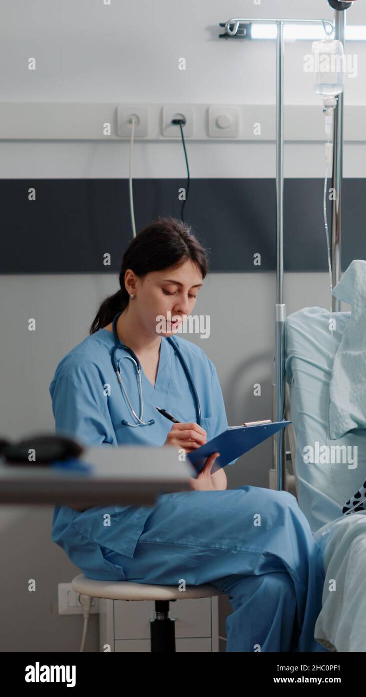 Medical assistant doing checkup visit with ill patient for healthcare ...