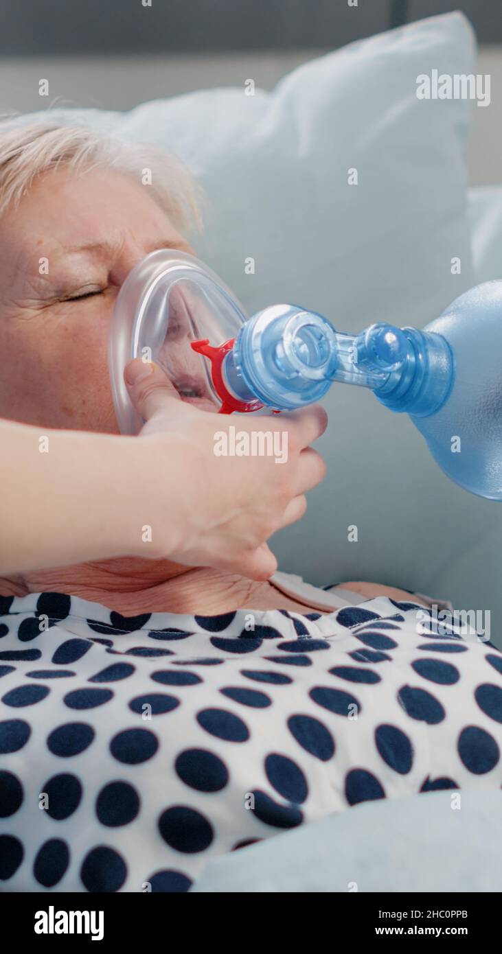 Close up of sick patient receiving help with oxygen tube for ...