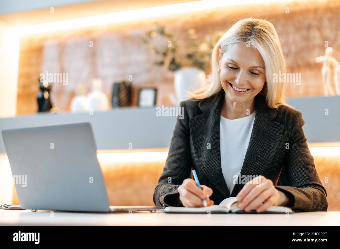 Happy smart caucasian businesswoman, tom manager, ceo, sitting at a ...