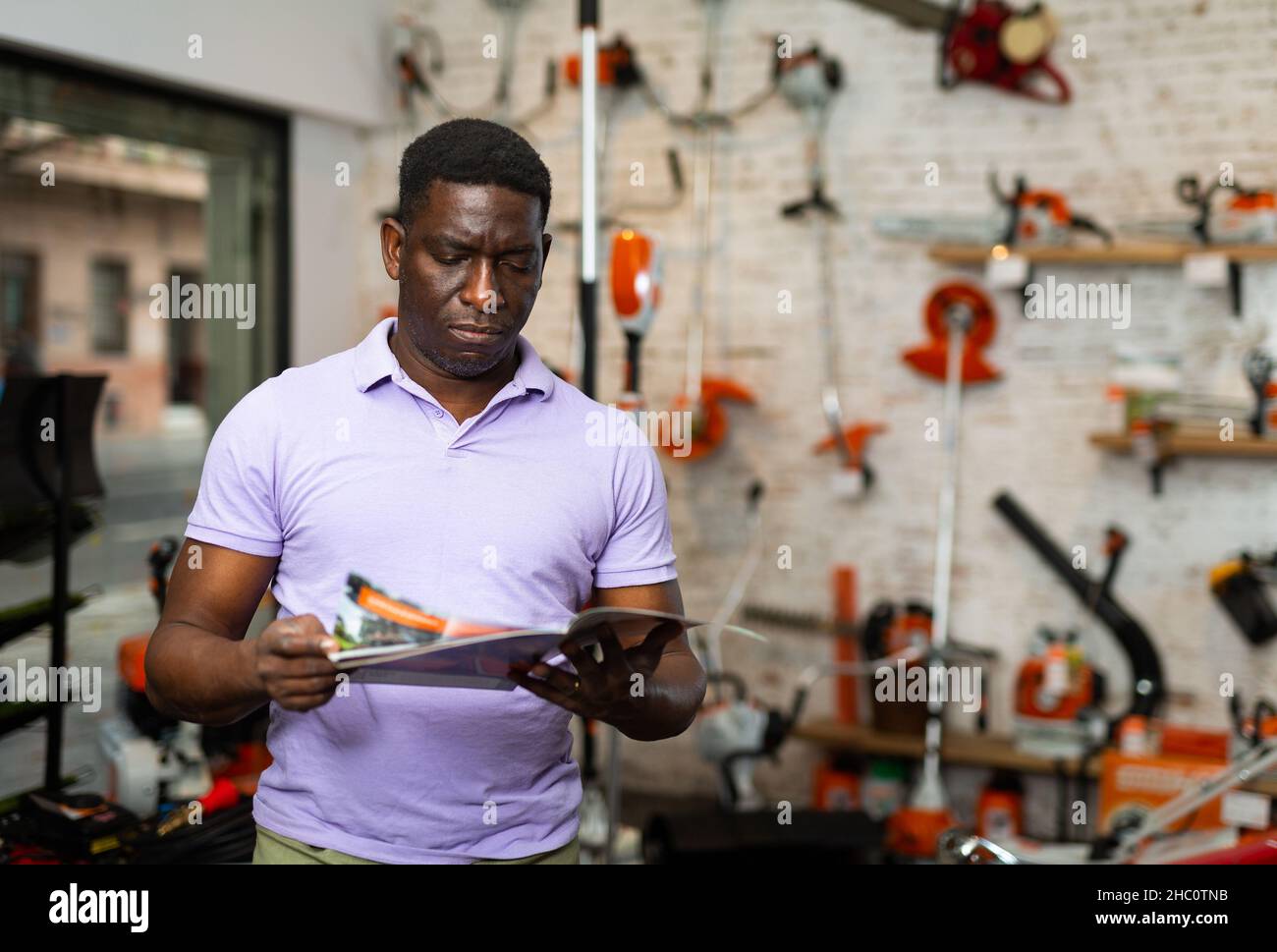 African american shopper carefully reads handout in tools store Stock ...
