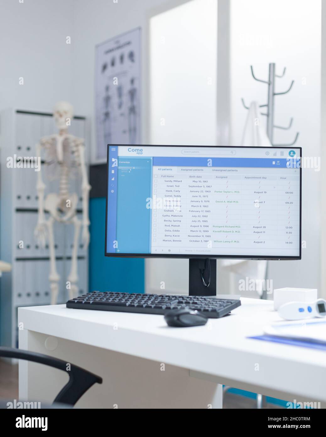 Empty doctors office having computer with patients files on screen ...