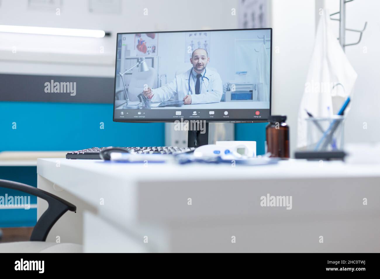 Empty doctor office with remote doctor having online videocall meeting ...