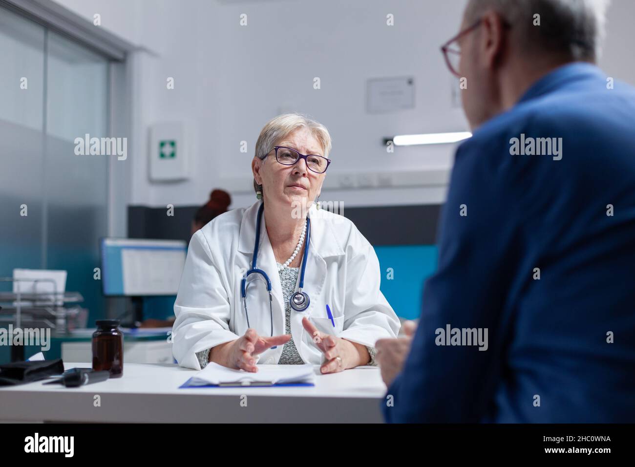 Doctor and patient meeting at consultation appointment to do healthcare ...