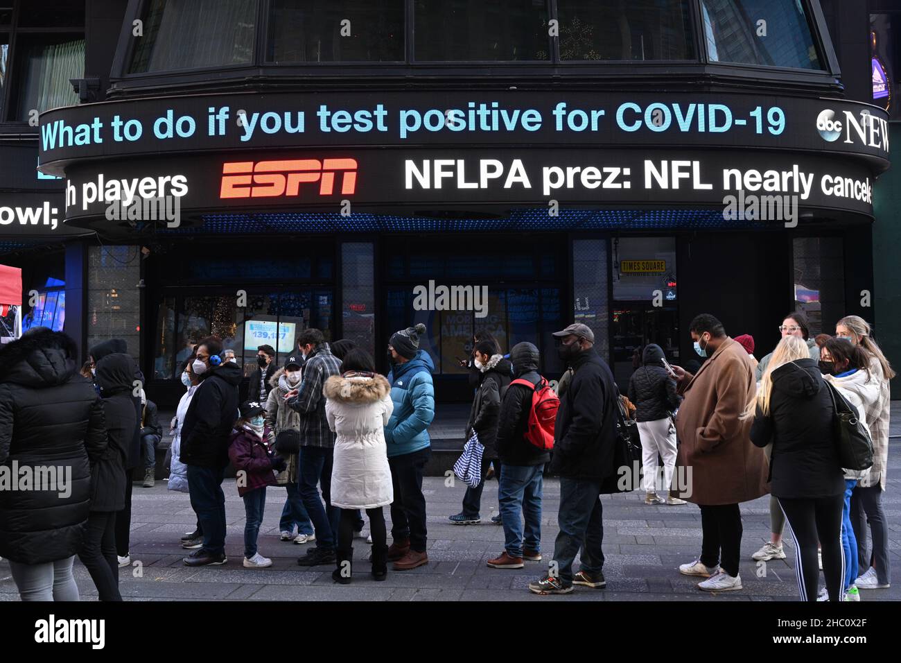 People wait in line for COVID-19 tests at a mobile testing site on ...