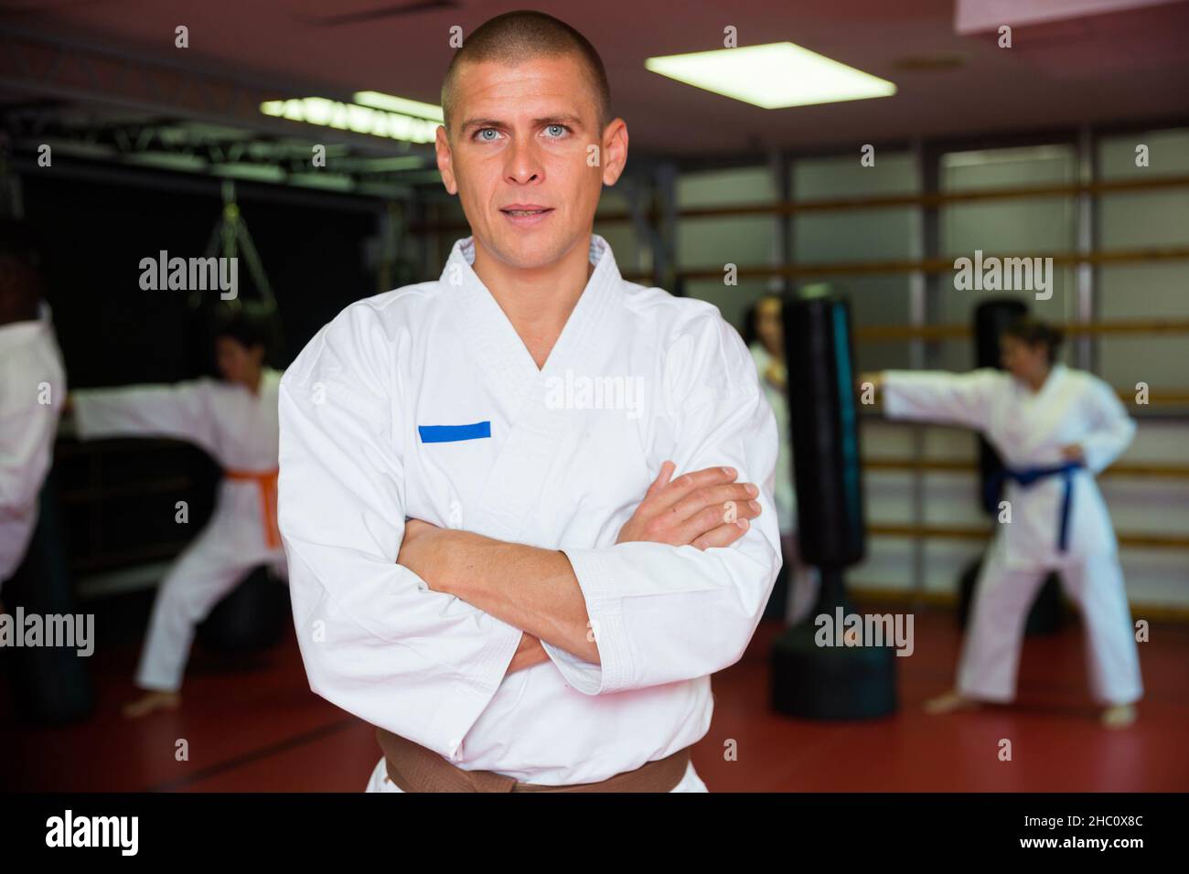 Karate trainer standing in gym Stock Photo - Alamy