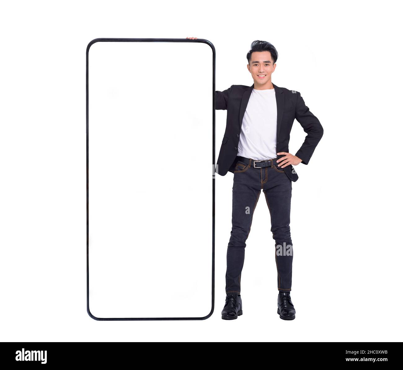 Happy young man standing with big Smartphone and Blank White Screen ...