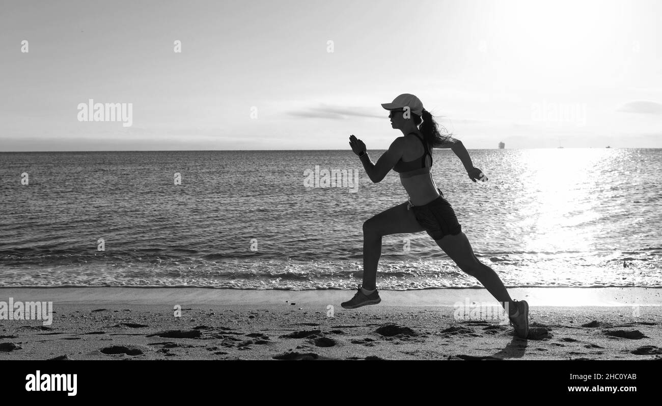 Female runner running on beach Black and White Stock Photos & Images ...