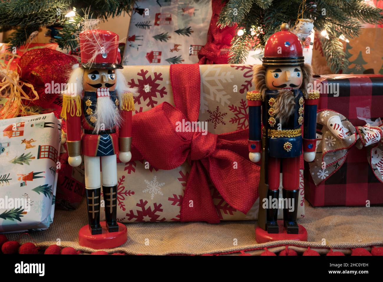 Two Nutcrackers under the Christmas tree with Presents Stock Photo - Alamy