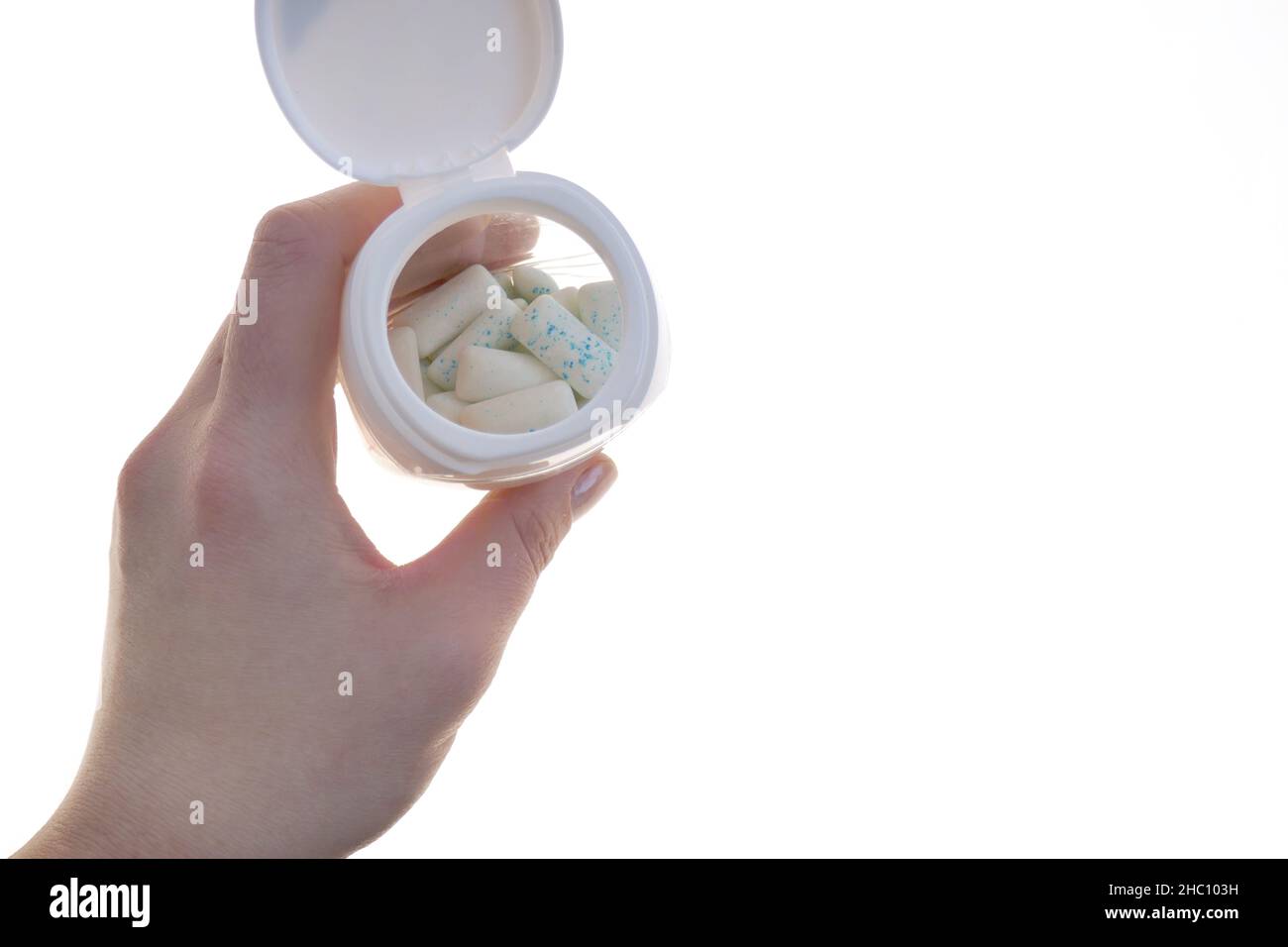 Bubble Gum. Chewing gum pads in a jar in hand on a white background ...