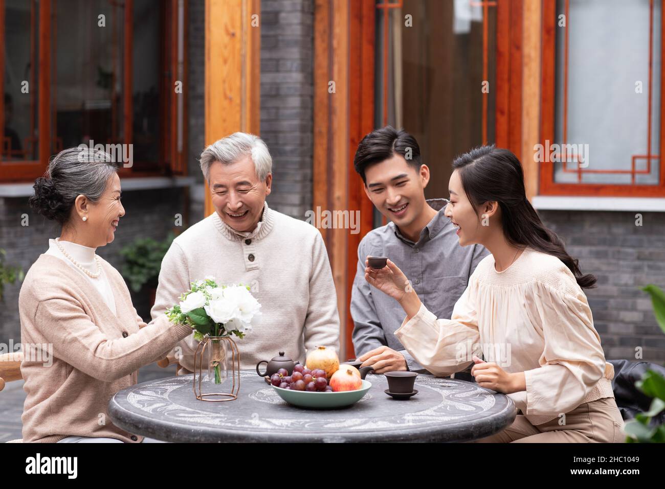Happy families drinking tea and chatting in the courtyard Stock Photo ...