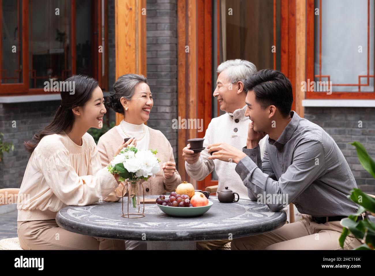 Happy families drinking tea and chatting in the courtyard Stock Photo ...