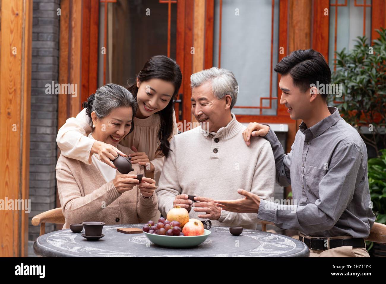 Happy families drinking tea and chatting in the courtyard Stock Photo ...