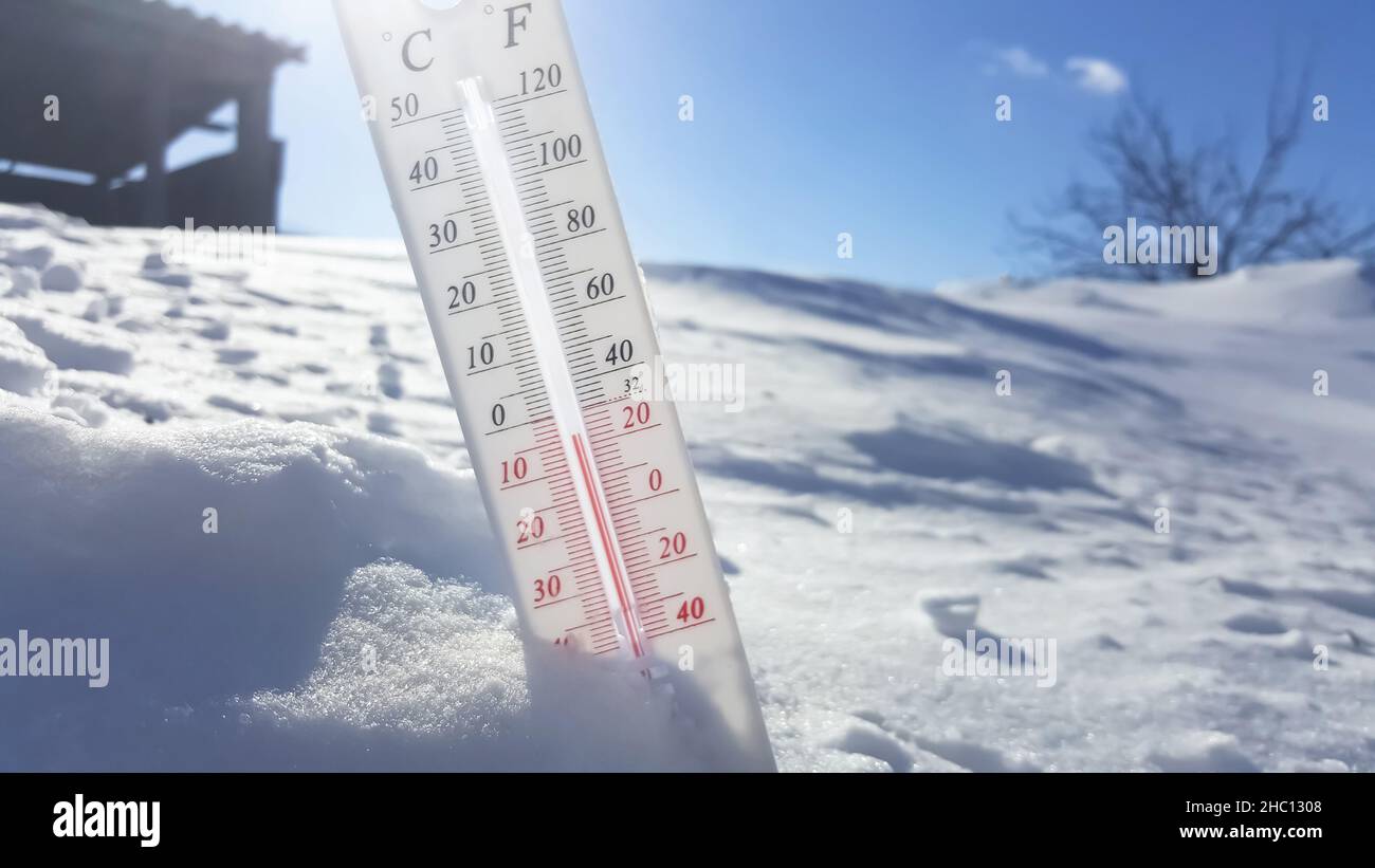 Thermometer in winter in the cold on snow and analyzes low negative air ...