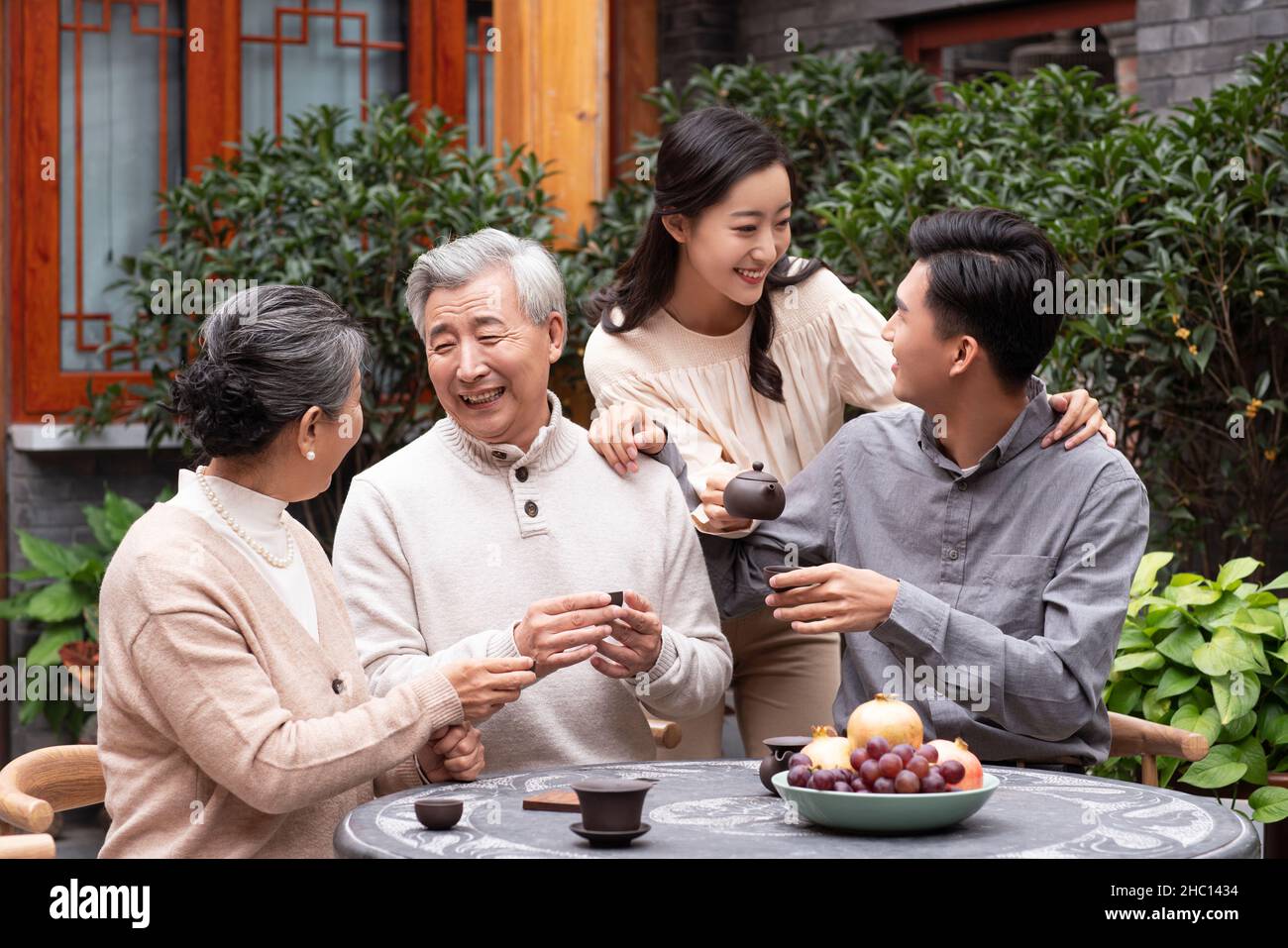 Happy families drinking tea and chatting in the courtyard Stock Photo ...