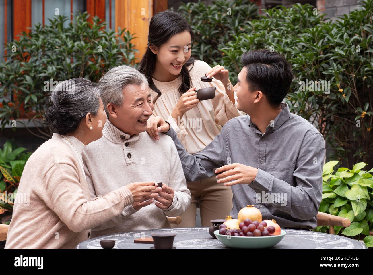 Happy families drinking tea and chatting in the courtyard Stock Photo ...