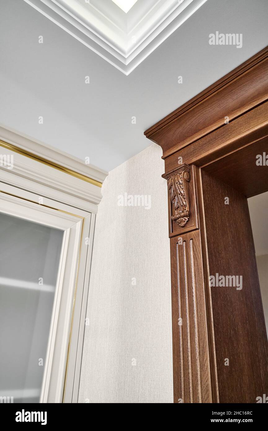 Decorated wooden doorway with carved furniture brackets and fluted ...