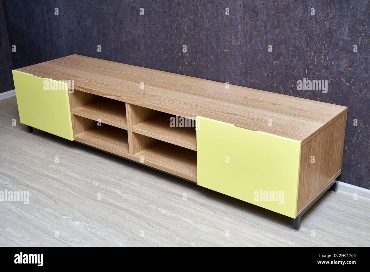 Elegant empty TV stand made of oak wood veneer with bright yellow ...