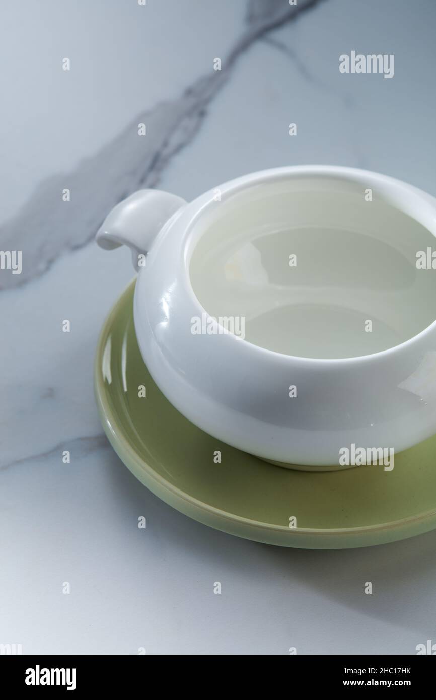 An aerial soup bowl is placed on the marble tile texture background ...