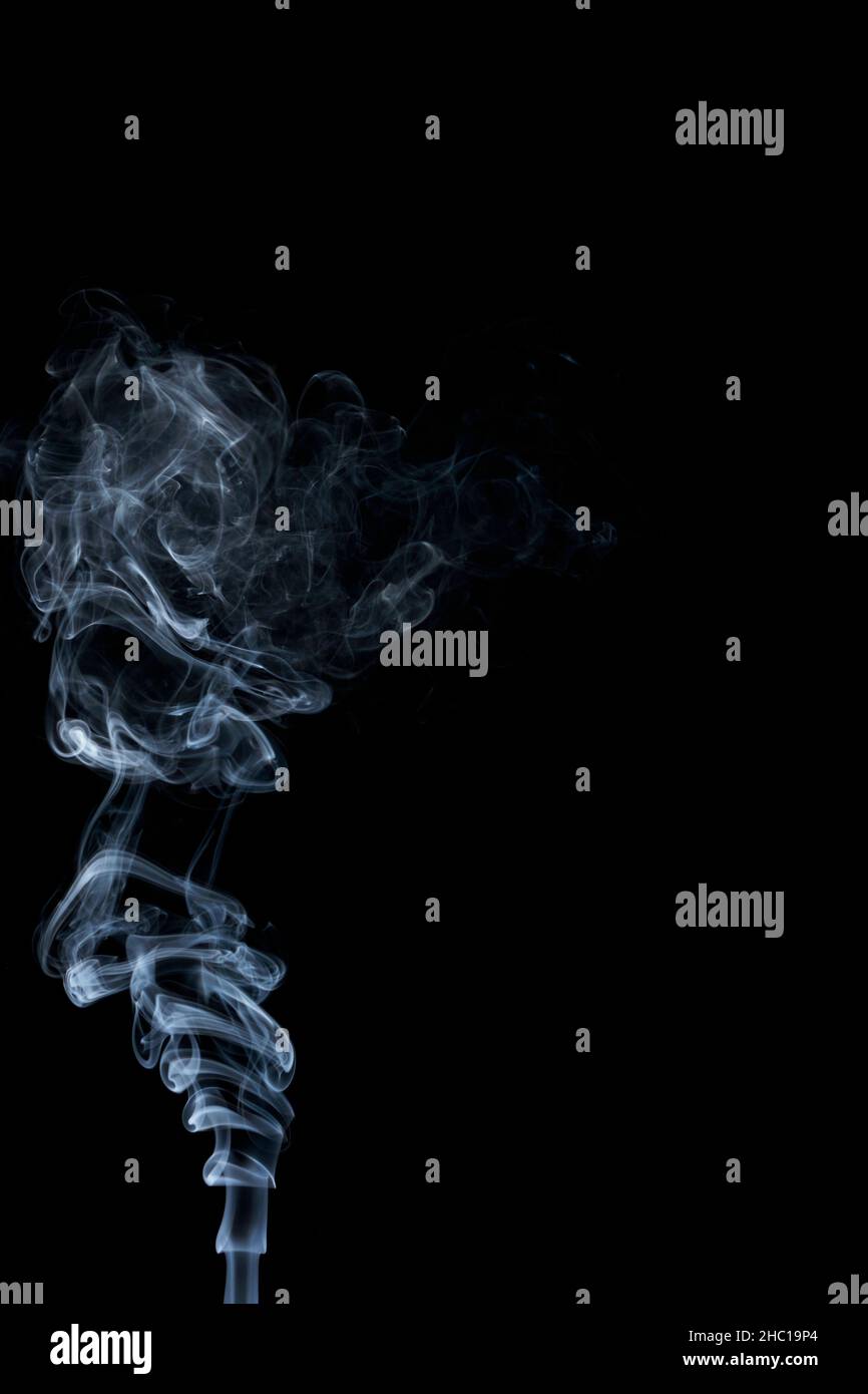 Clouds of curls of smoke on a black background Stock Photo - Alamy
