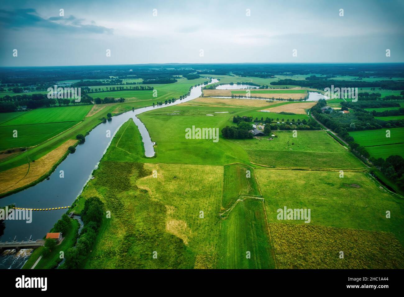 Drone view of the river Vecht, green grass, trees, beautiful blue sky ...