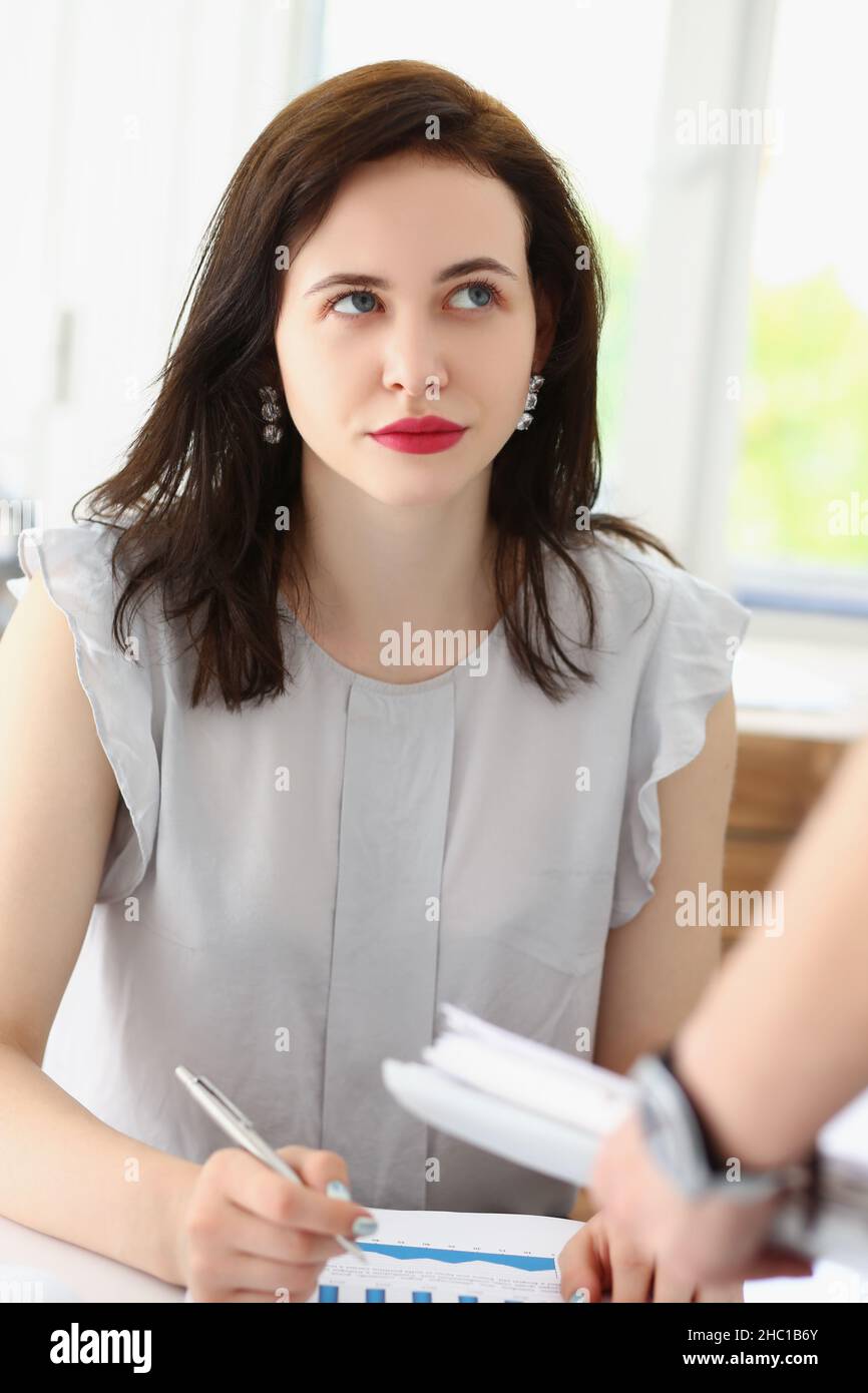 Pretty brunette female office worker listen to coworker ideas ...