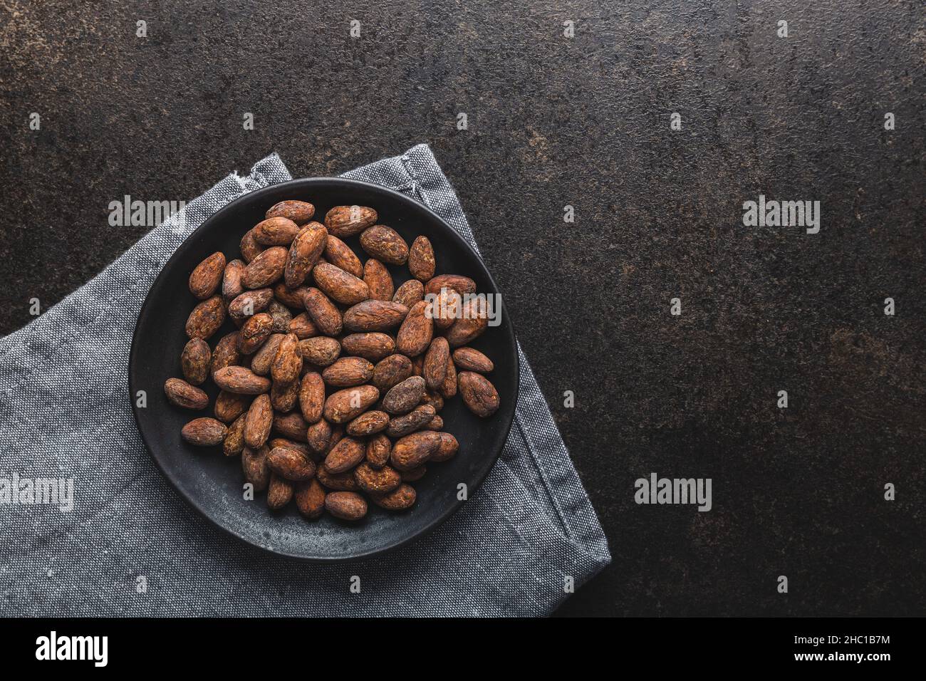 Dried cocoa beans. Cacao beans on plate. Top view Stock Photo - Alamy