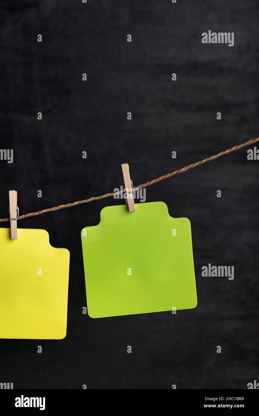 Blank green paper notes hang with clothespin on rope. Copy space. Place ...