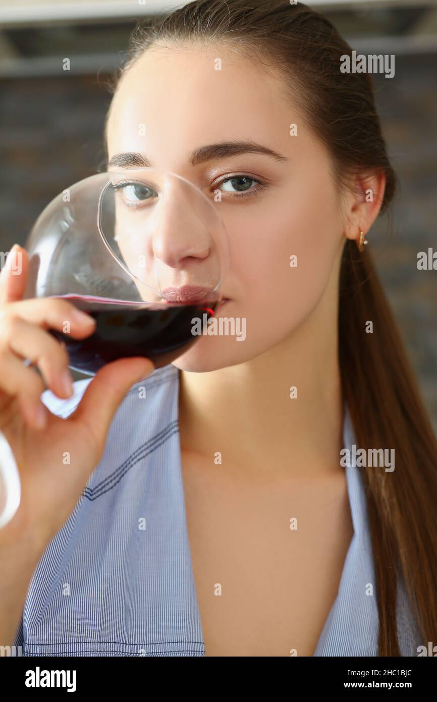 Female drinking red wine from glass and enjoying tasty drink Stock ...