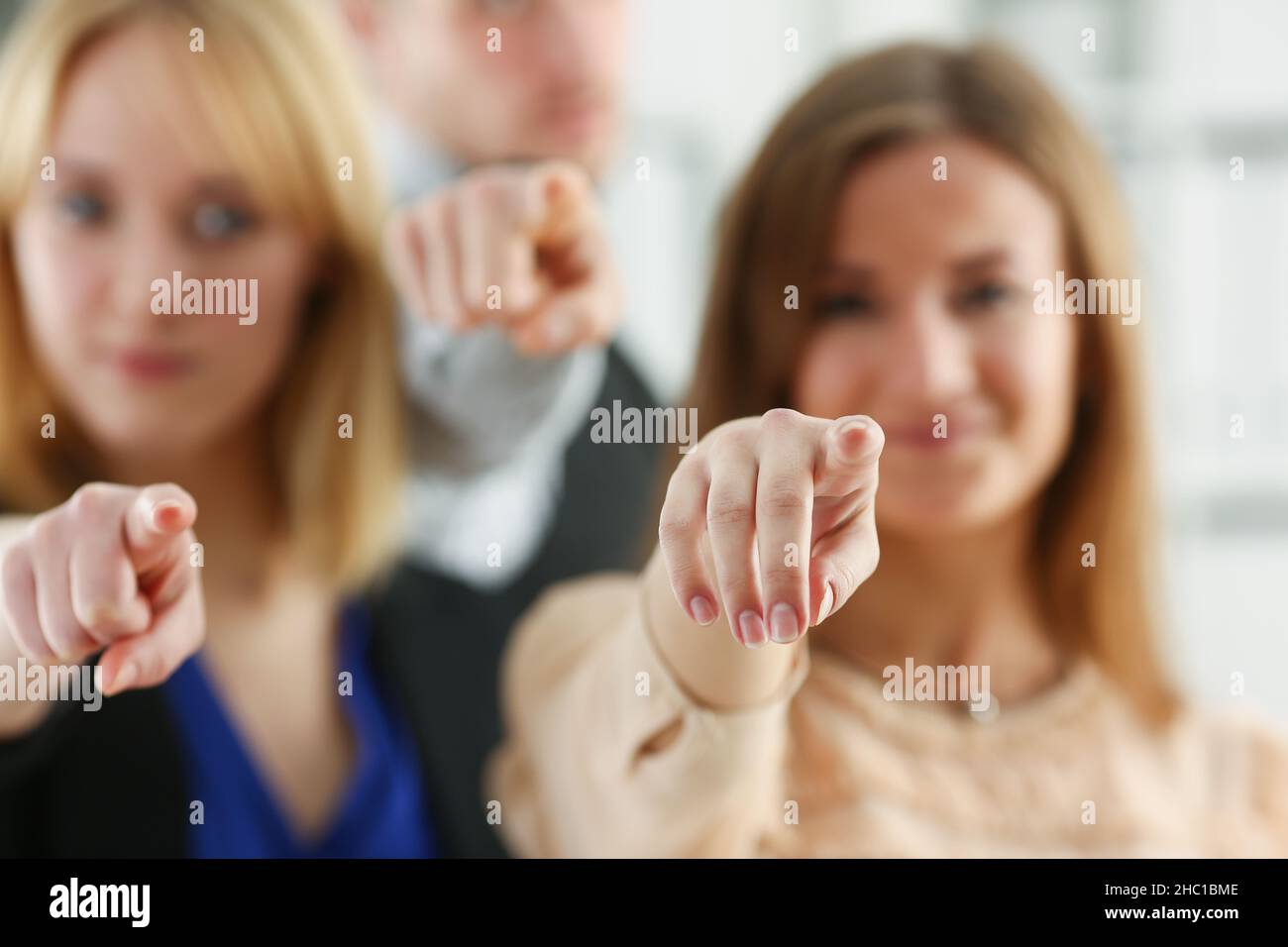 Group of businesspeople pointing their finger at the camera and saying ...