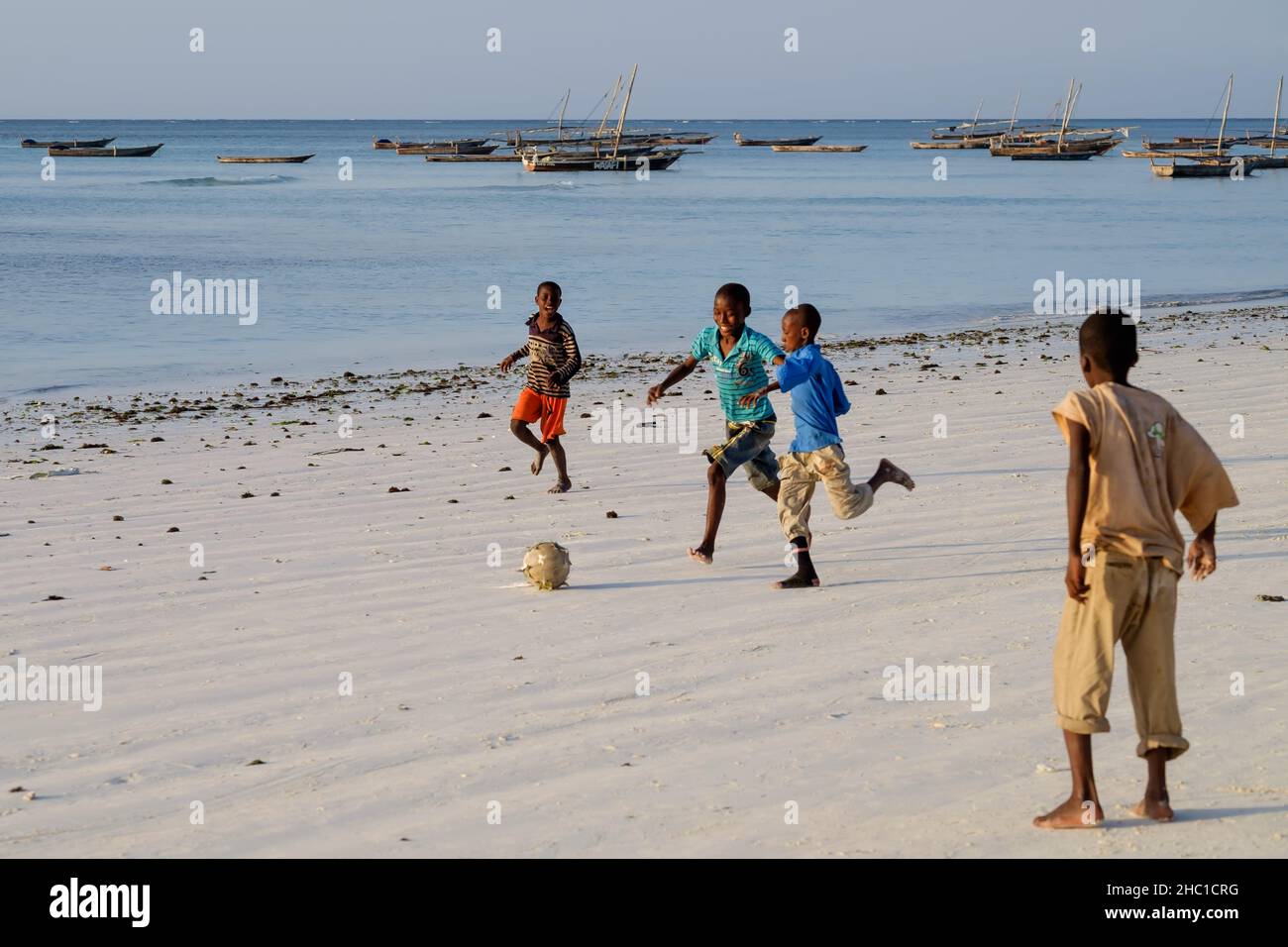 All the locals in Zanzibar go out at sunset to enjoy the beach Stock ...