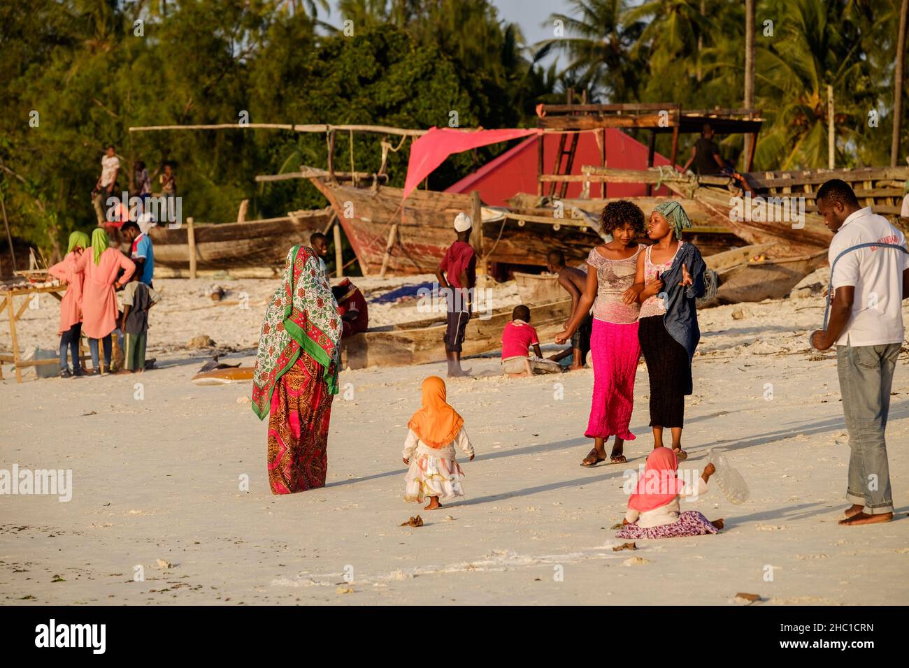 All the locals in Zanzibar go out at sunset to enjoy the beach Stock ...