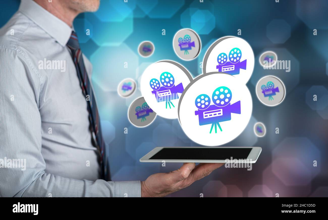 Cinema concept above a tablet held by a man Stock Photo - Alamy
