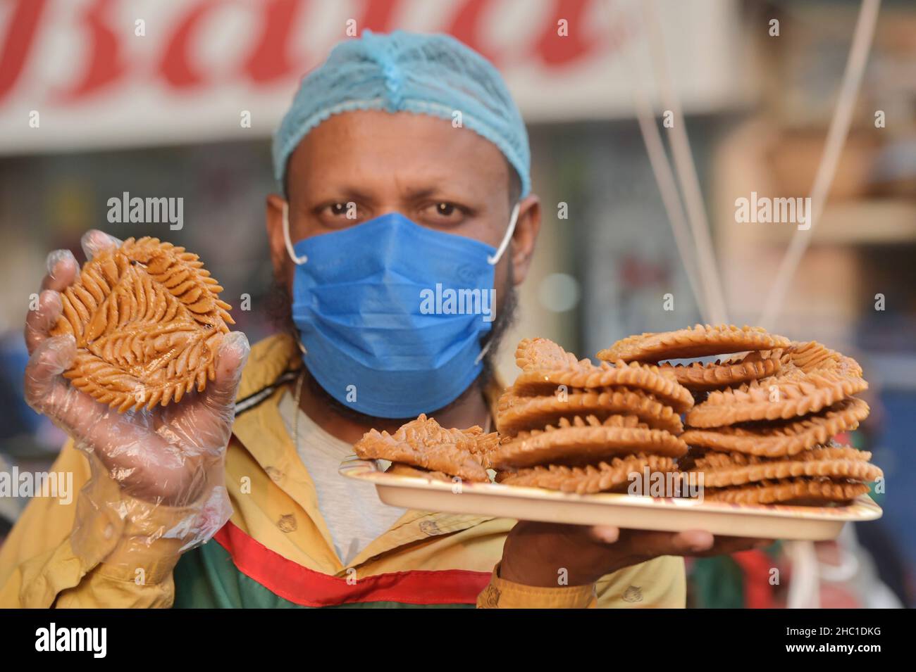 Dhaka. 21st Dec, 2021. A vendor displays winter cakes known as "Pitha ...