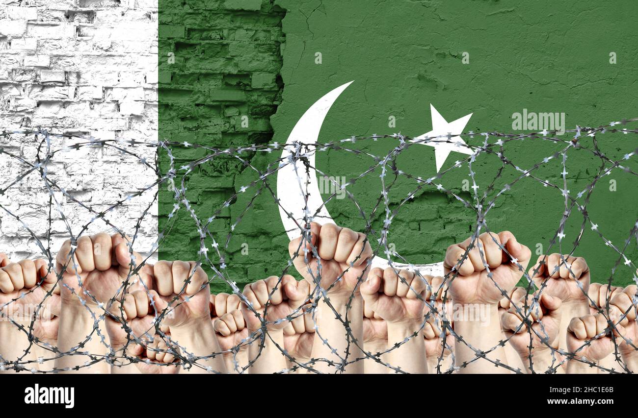 Barbed wire against the background of the inflicted flag of Pakistan ...