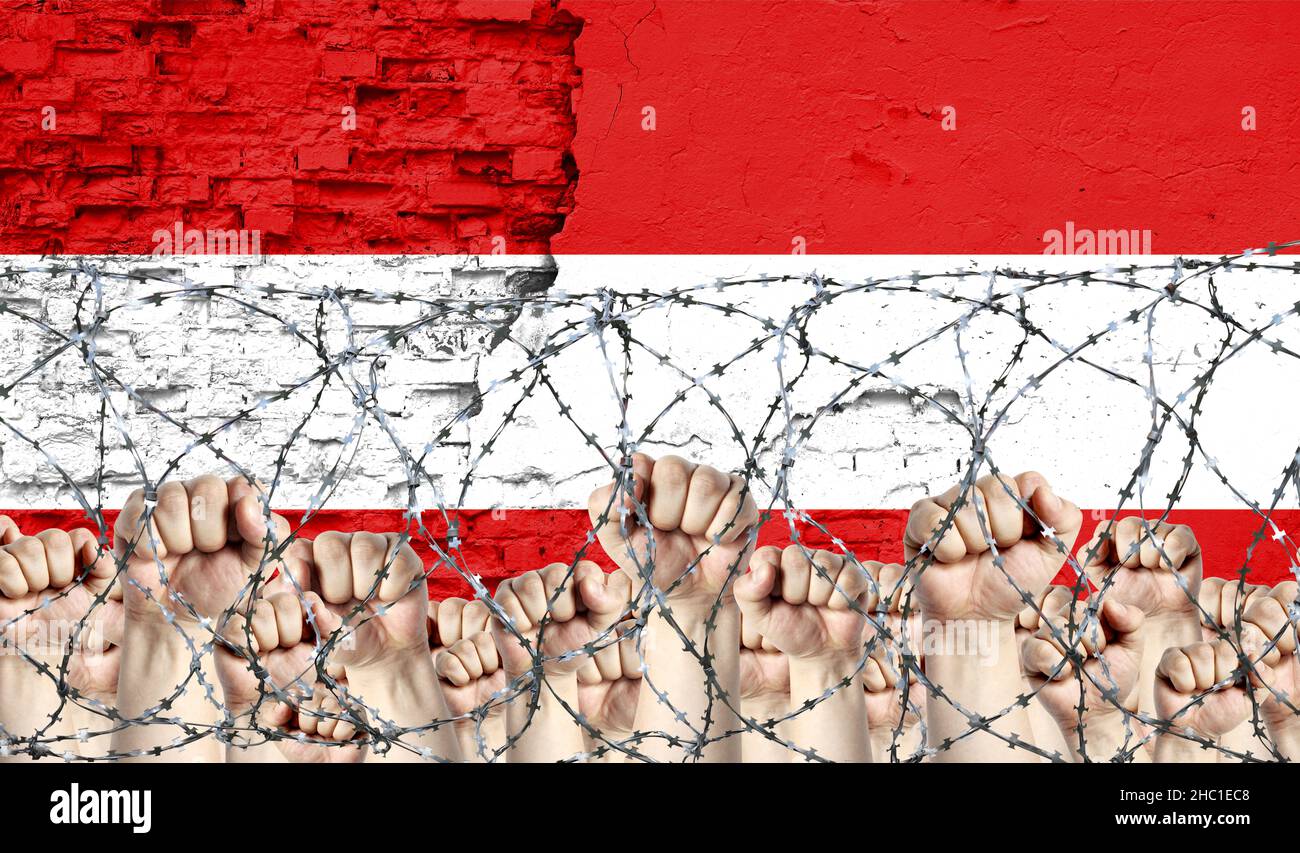 Barbed wire against the background of the inflicted flag of Austria and ...