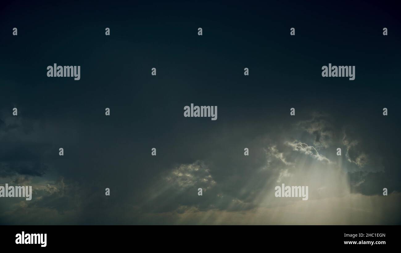 4K Sun Rays Shining Through Dark Storm Cloudy Rainy Sky With Fluffy ...