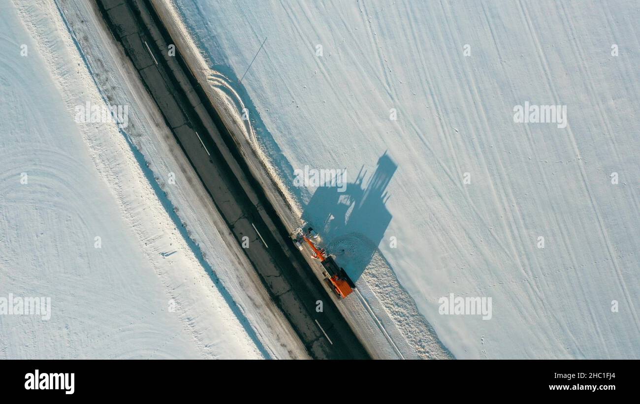 Aerial View Snow Removal Tractor Clears Road From Snow. Bird's Eye View ...